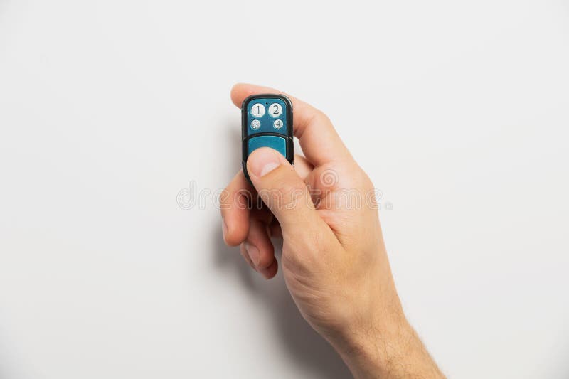 Remote Control for Door or Garage or Gate in Male Hand on White ...