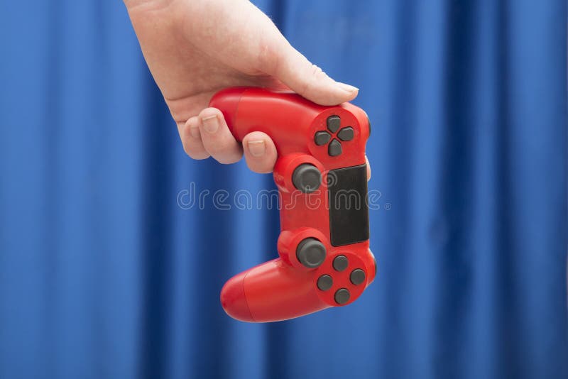 Remote Control for a Game Console.a Young Man is Playing a Game Console ...