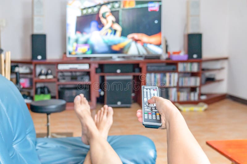 Remote Control in Hand. Watching TV in Livingroom Stock Image - Image ...