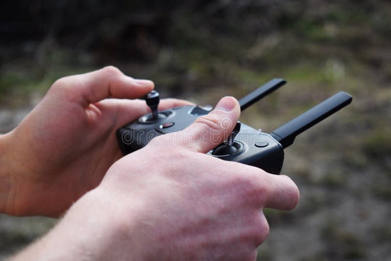 Remote Controller in Male Hands. Man Holding Transmitter and Piloting ...