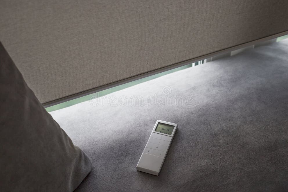 Remote Control on a Sofa Under Partially Closed Blinds in Modern Living ...