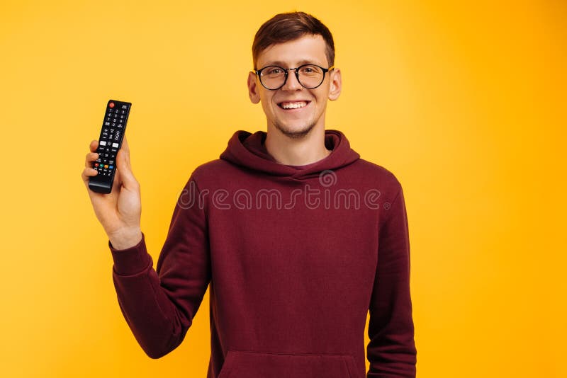 Remote Controlled Man. Cheerful Man Holding a Remote Control in His ...