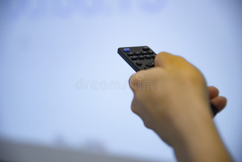 A Remote Controller with Left Hand Behind the White Board at the Office ...