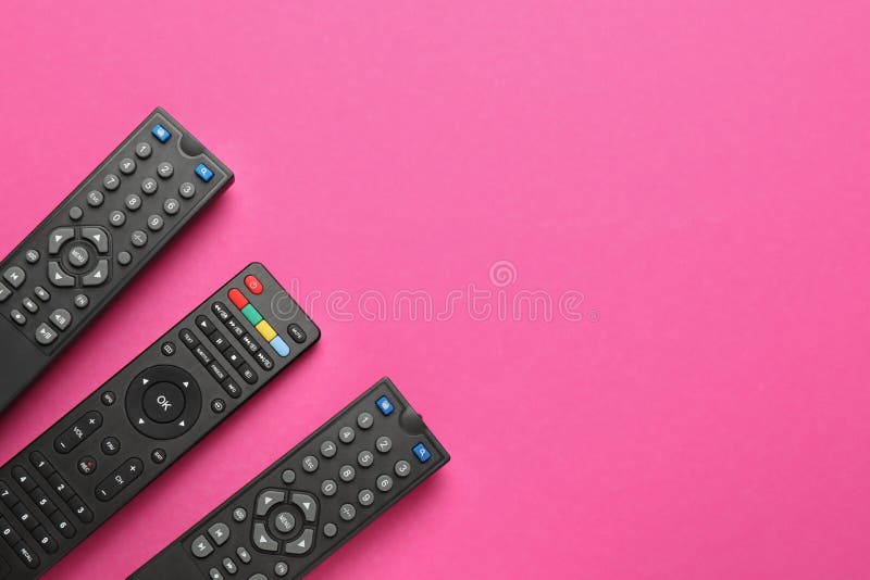 Remote Controls on Pink Background, Flat Lay. Space for Text Stock ...