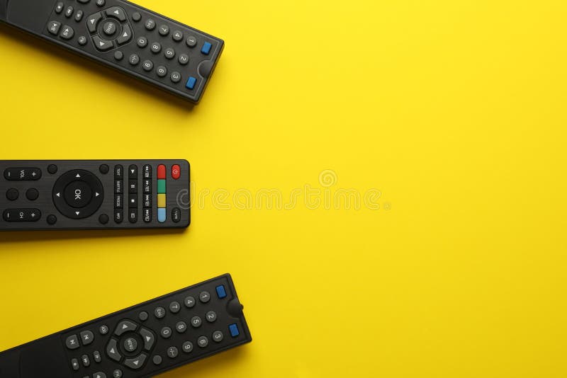 Remote Controls on Yellow Background, Flat Lay. Space for Text Stock ...