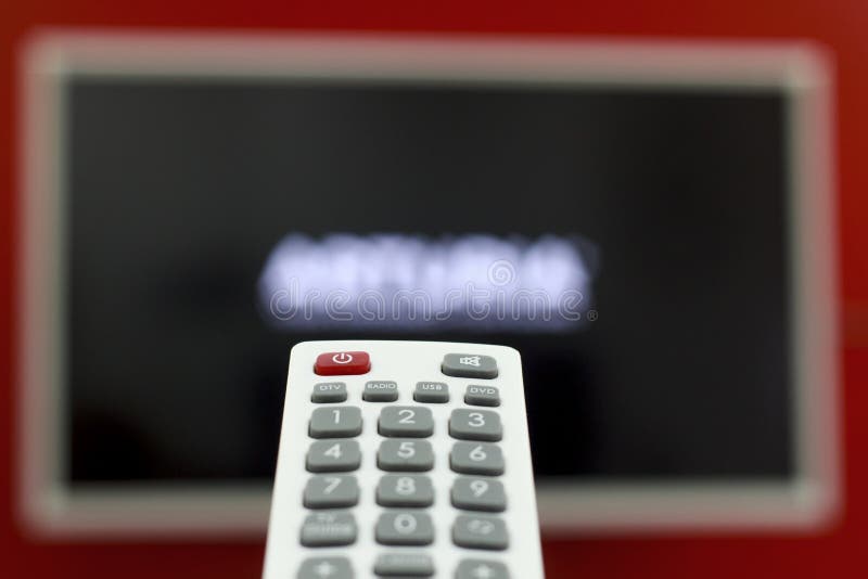 The Remote in the Hand Switch Channels on the TV Hanging on the Red ...