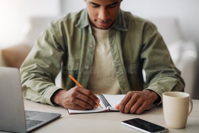 Remote Learning Concept. Black Student Writing in Notebook during ...