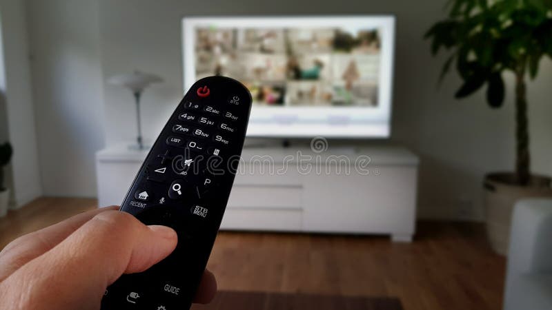 Hand Pointing A Tv Remote Control Towards The Television. Stock Photo ...