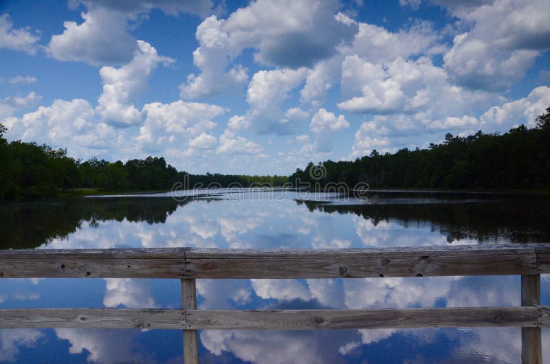 Reflecting Lake with Clouds Stock Image - Image of pond, white: 154454431