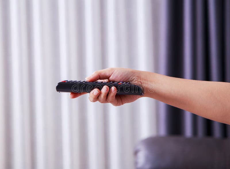 Remote tv in hand stock image. Image of enjoying, blinds - 103974123