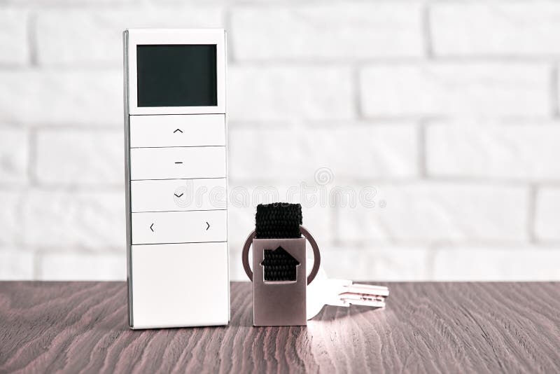 Remote Wireless Digital Security Controller and Door Keys on the Table ...