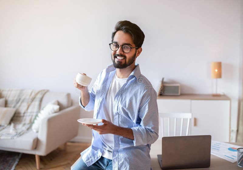 Remote Work Advantages. Happy Arab Freelancer Guy Drinking Coffee at ...