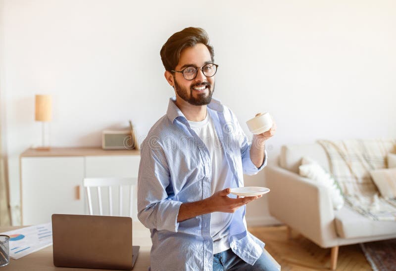 Remote Work Advantages. Happy Arab Freelancer Guy Drinking Coffee at ...