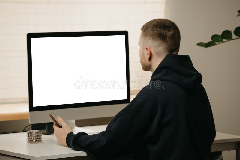 A Back View of a Businessman Works Remotely Using an All-in-one ...