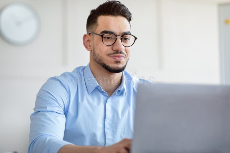 Handsome Arab Man Using Laptop Pc, Searching Info on Web at Modern ...