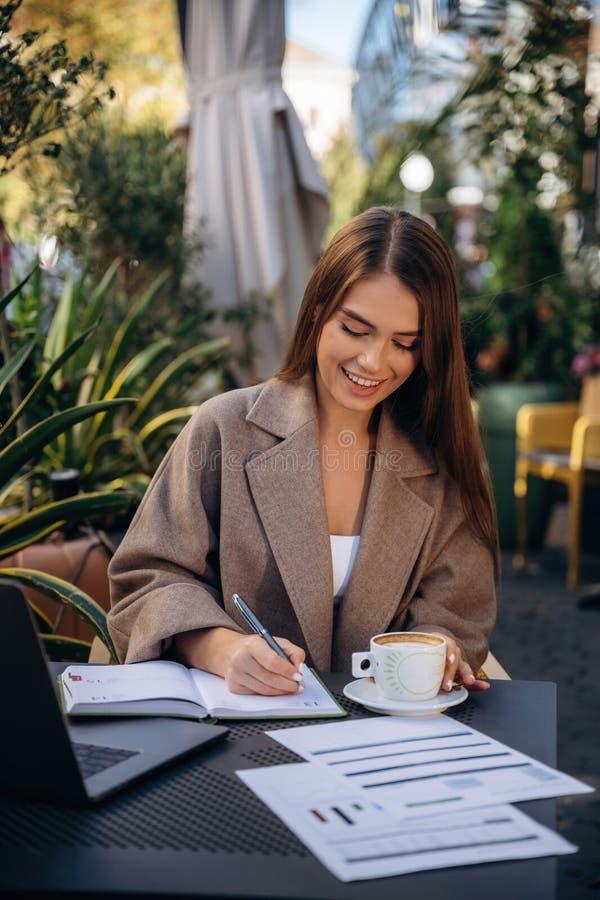 Remote Work, with Drink and Documents. Beautiful Young Woman is ...