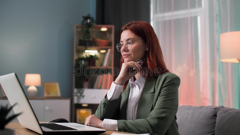Remote Work, Female Office Employee Working at a Laptop Making Notes in ...