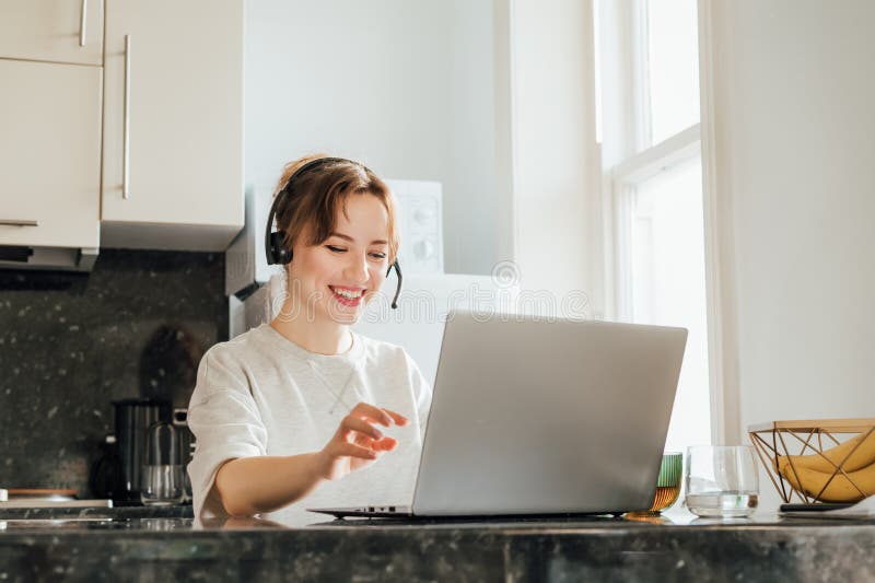 Remote Work at Home. Emotional Woman in Headset Working on Laptop at ...