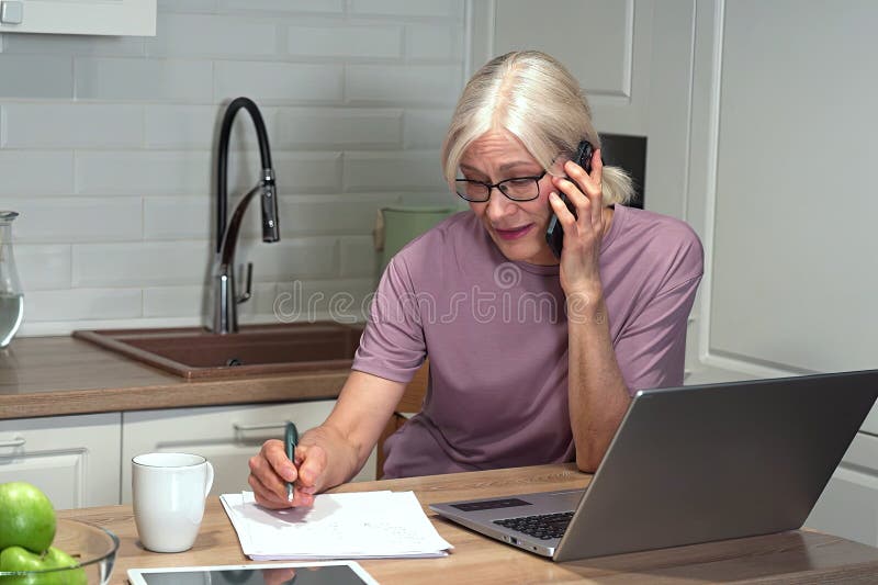 Remote Work: a Mature Woman Combines Calls and Appointments Stock Photo ...