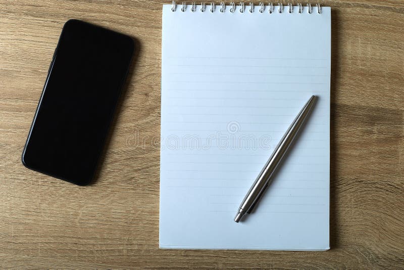 Remote Work Phone Notepad with Pen on the Table Stock Photo - Image of ...