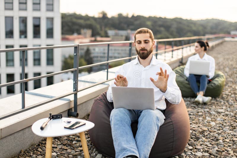 Remote Work on Rooftop with Laptops and Bean Bags Stock Photo - Image ...