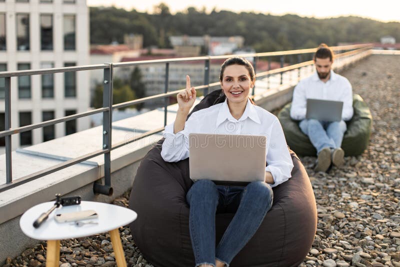 Remote Work on Rooftop with Laptops in Bean Bags Stock Photo - Image of ...