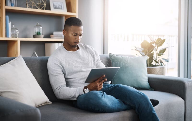 Remote Work, Tablet and Man on Sofa Reading Email, Social Media Post or ...