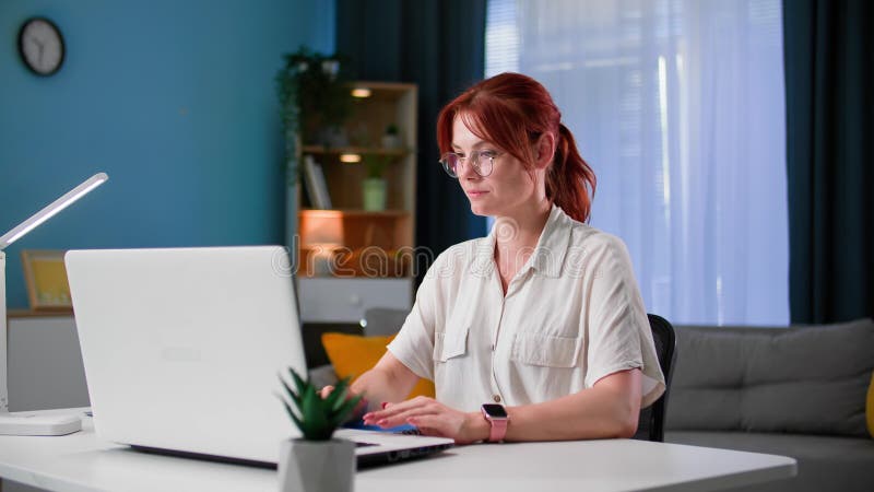 Remote Work, Young Woman in Glasses Working at a Computer Sitting at ...