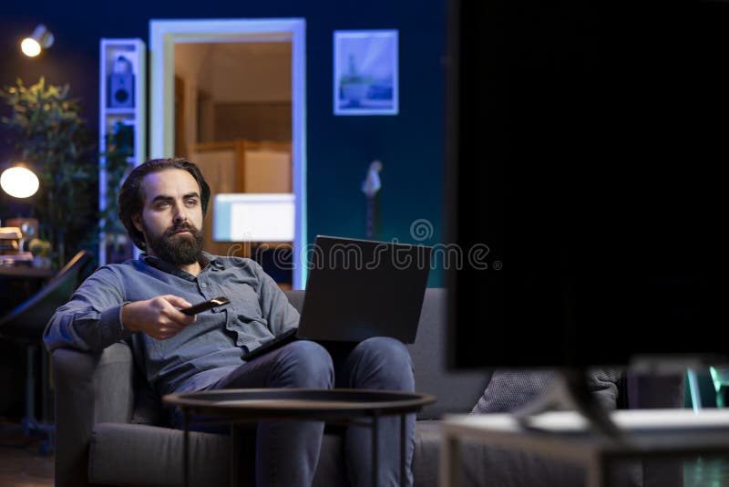 Remote Worker Solving Tasks on Notebook and Browsing through Shows ...