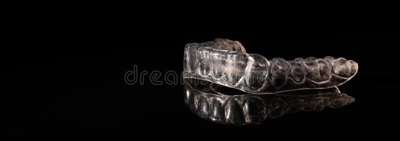 Removable Plastic Retainers for Bite Correction on a Black Background ...