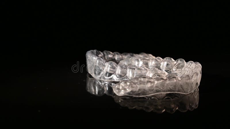 Removable Plastic Retainers Spin Against a Black Background Stock ...