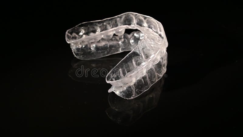 Removable Plastic Retainers Spin Against a Black Background Stock ...