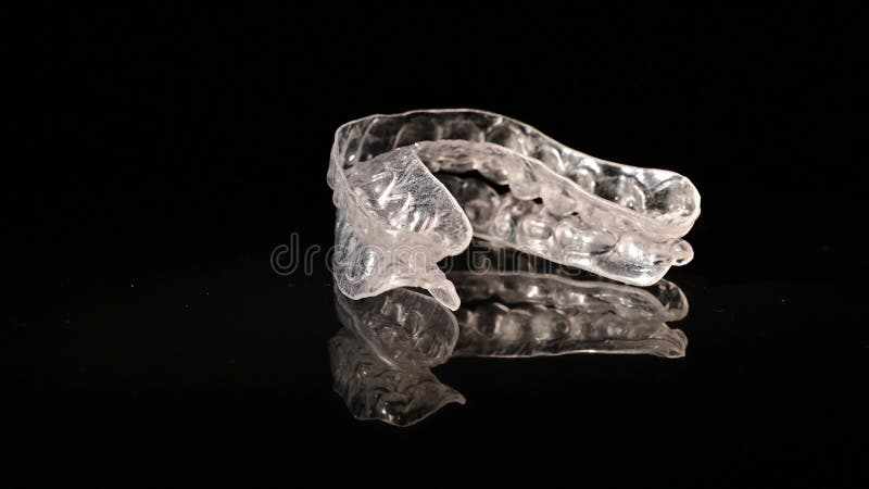 Removable Plastic Retainers Spin Against a Black Background Stock Video ...