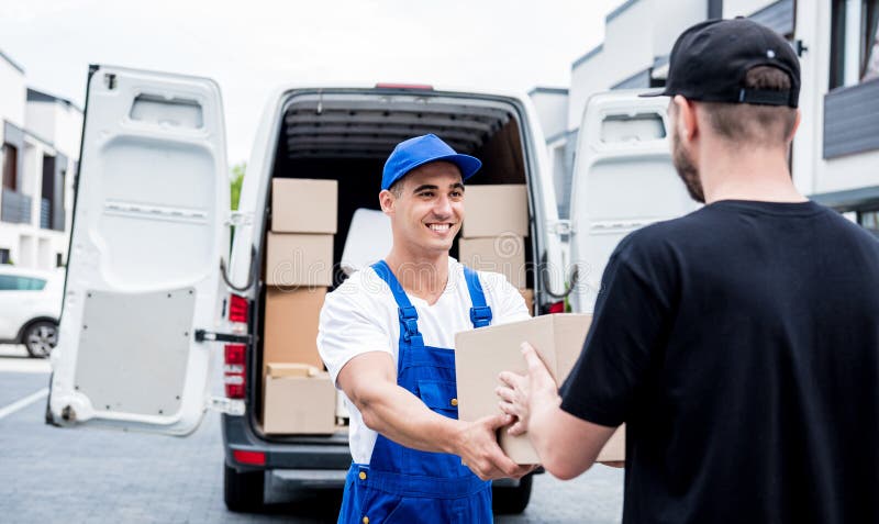 Removal Company Worker Unloading Boxes from Minibus into Customer S ...