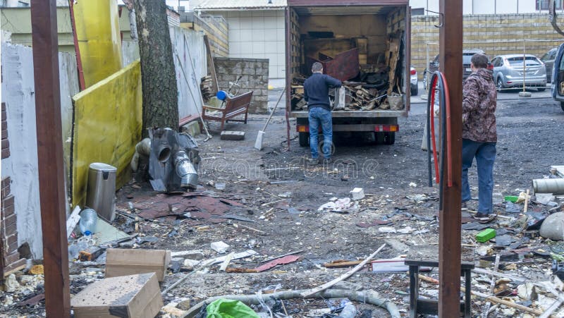 Removal of Construction Debris. Loading the Garbage Can Waste ...