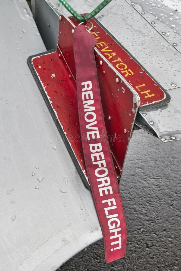 A Remove before Flight Ribbon on a Airplane Stock Image - Image of ...