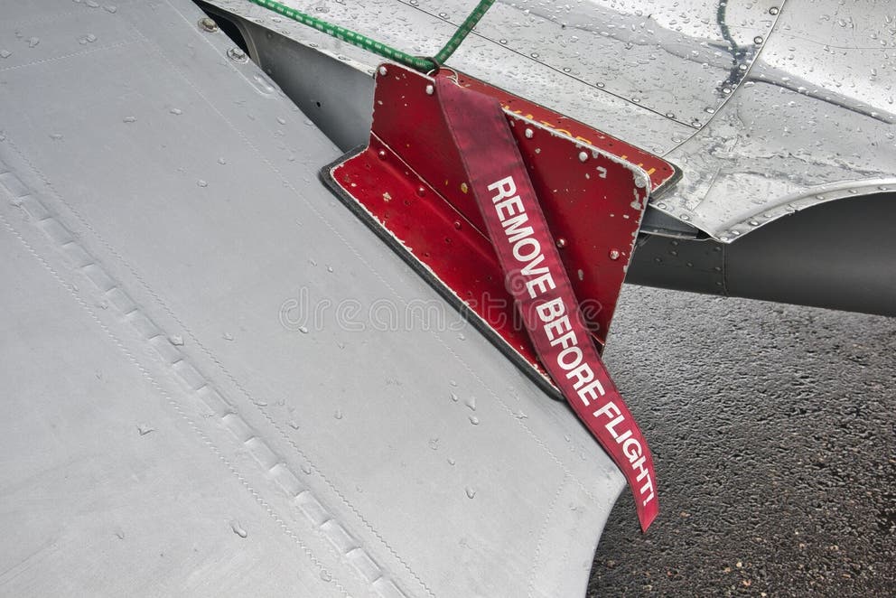 A Remove before Flight Ribbon on a Airplane Stock Image - Image of ...