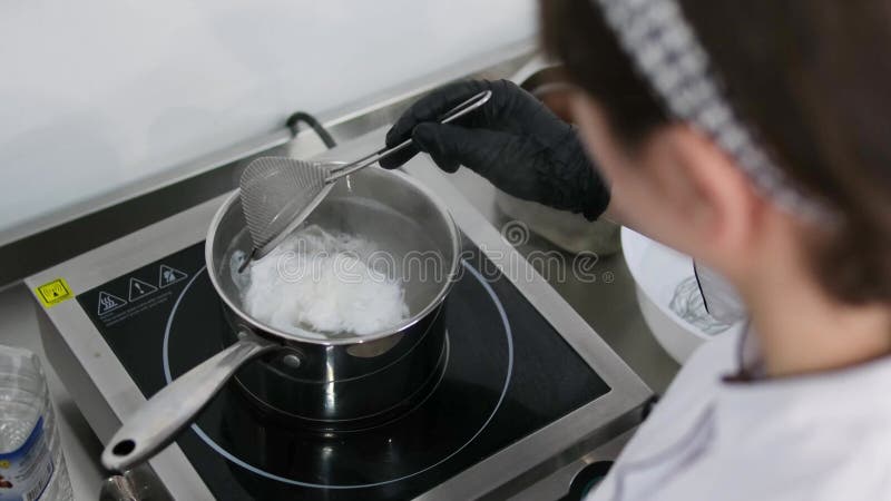 Taking Out Poached Egg from Boiling Water with Strainer, Static Side ...