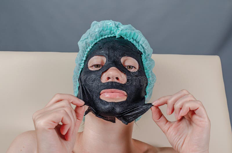 Removing the Cosmetic Black Fabric Mask from the Face Rejuvenating ...