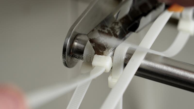 Removing by Cutting Off Attached Plastic Cable Ties from a Metal ...