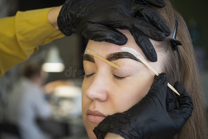 Removing Eyebrows with Hot Wax. Experienced Cosmetician Pulling Out ...