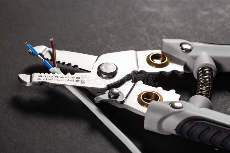 Removing the Insulation from the Conductor Using a Tool. Wire Stripping ...