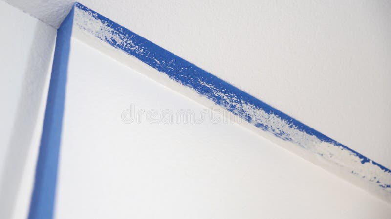 Man Removing Masking Tape from Skirting Board Stock Photo - Image of ...