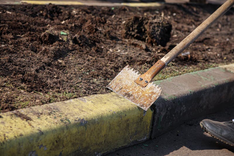 Removing Old Yellow Paint with Long Scraper from a Curb Stock Image ...