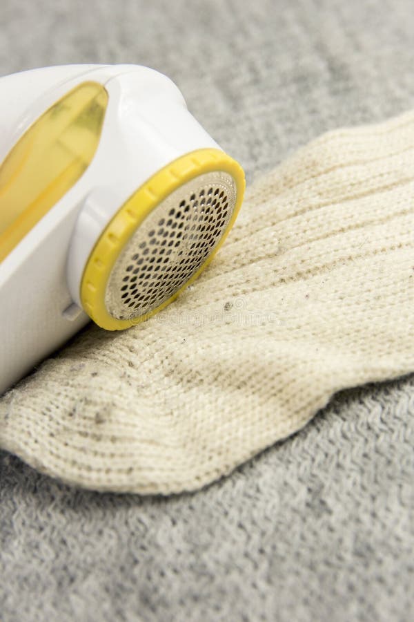 Removing Sheaving Lint Fuzz from White Woolen Socks. Stock Image ...