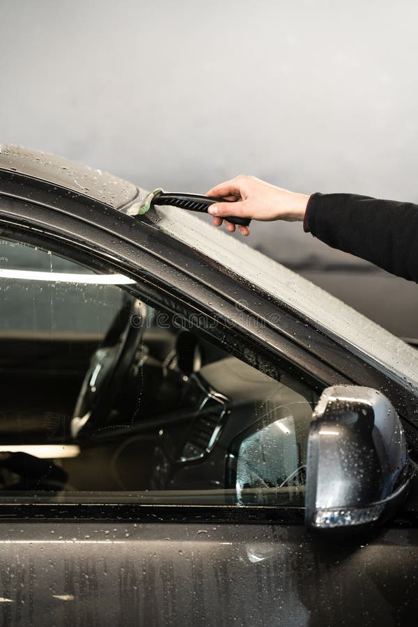 Removing Water from Windscreen Using Scraper at Car Wash Service ...