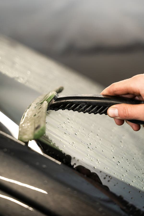 Removing Water from Windscreen Using Scraper at Car Wash Service ...