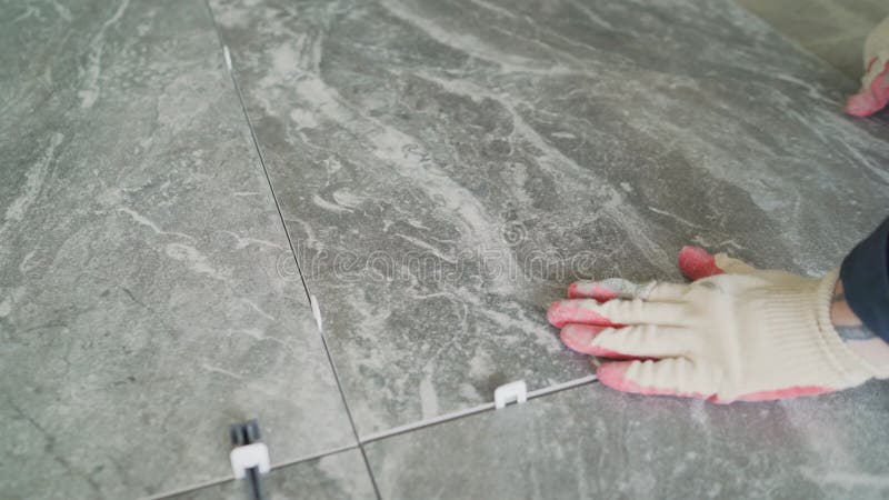 Renovating the Floor. Construction Workers Laying Tile Over Concrete ...
