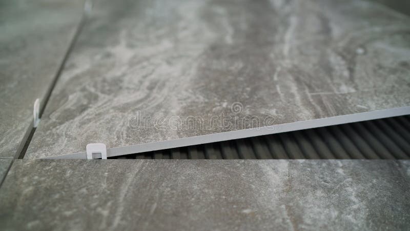 Renovating the Floor. Construction Workers Laying Tile Over Concrete ...