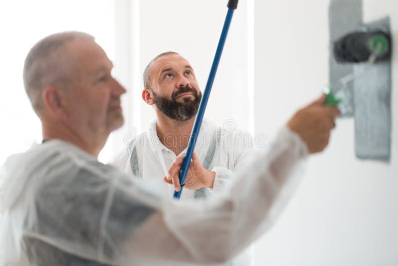 Renovation Crew Painting Wall Grey with Painting Roll Stock Image ...